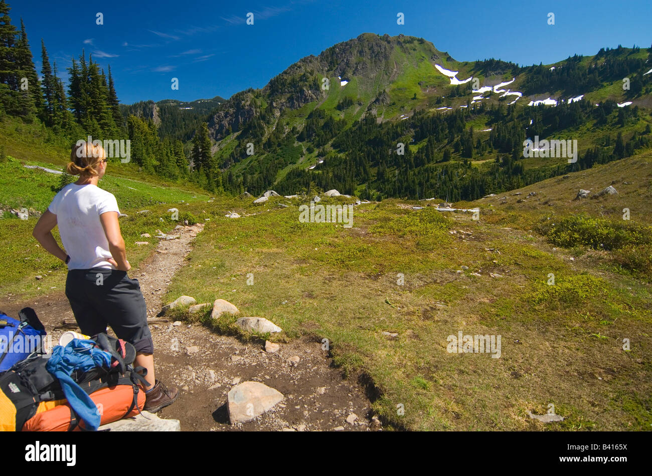 USA, Washington, Olympic National Park. A female hiker rests at Heart ...