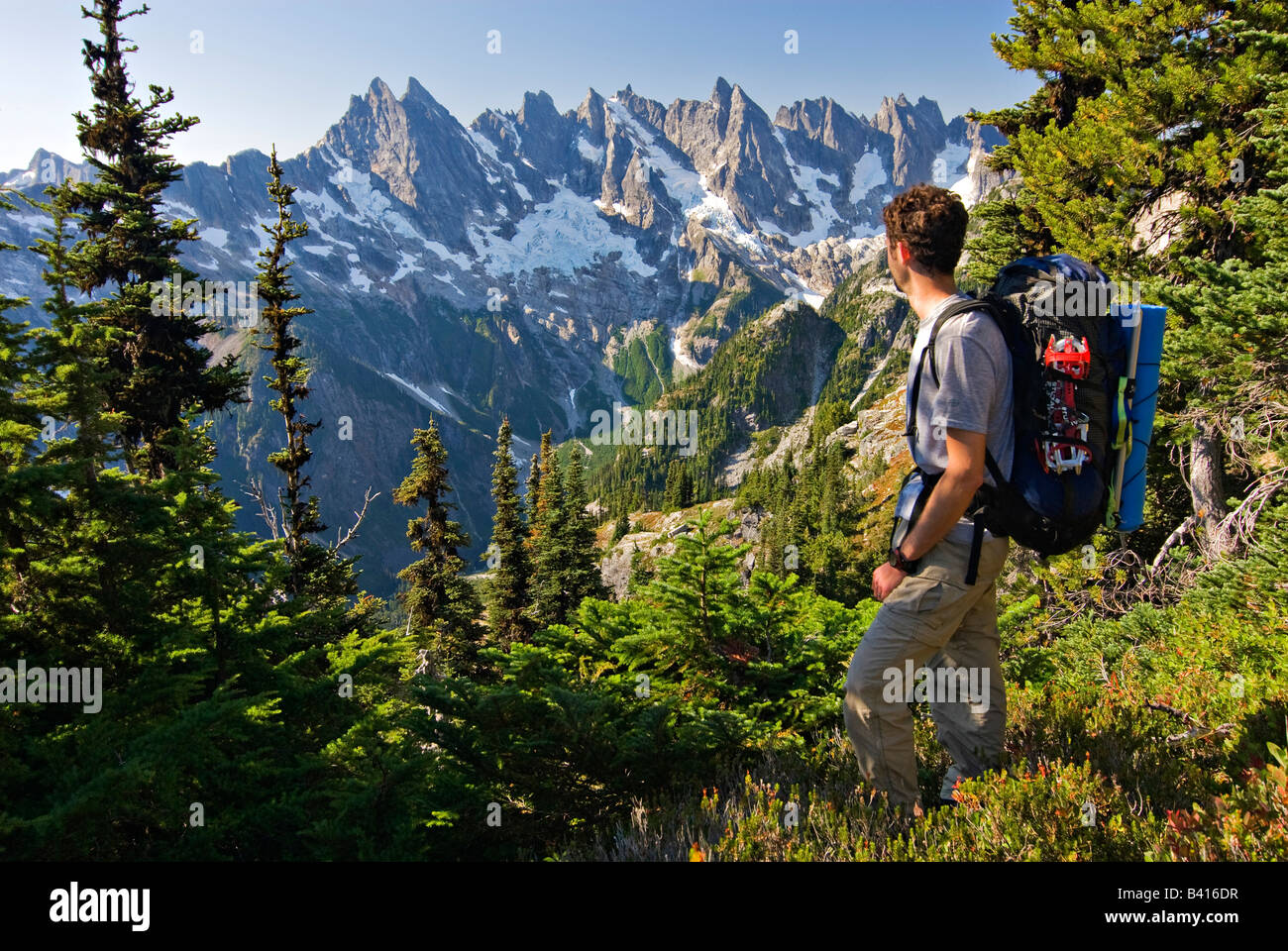 USA, Washington, North Cascades Nat'l Park. A hiker looks out at the ...