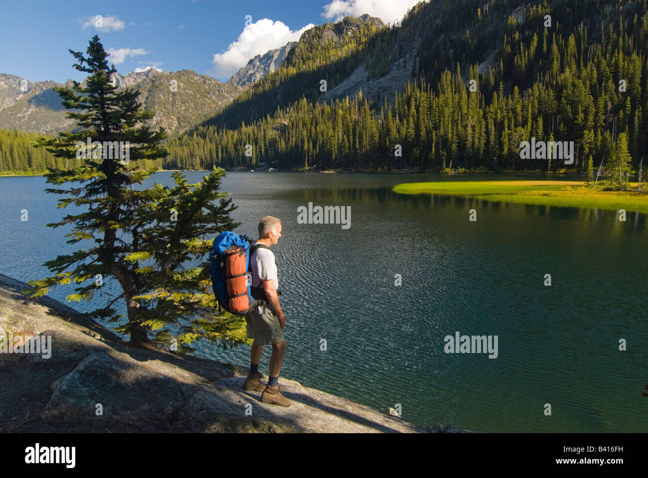 USA, Washington, Cascade Mountains. A senior citizen hiker at Lake ...