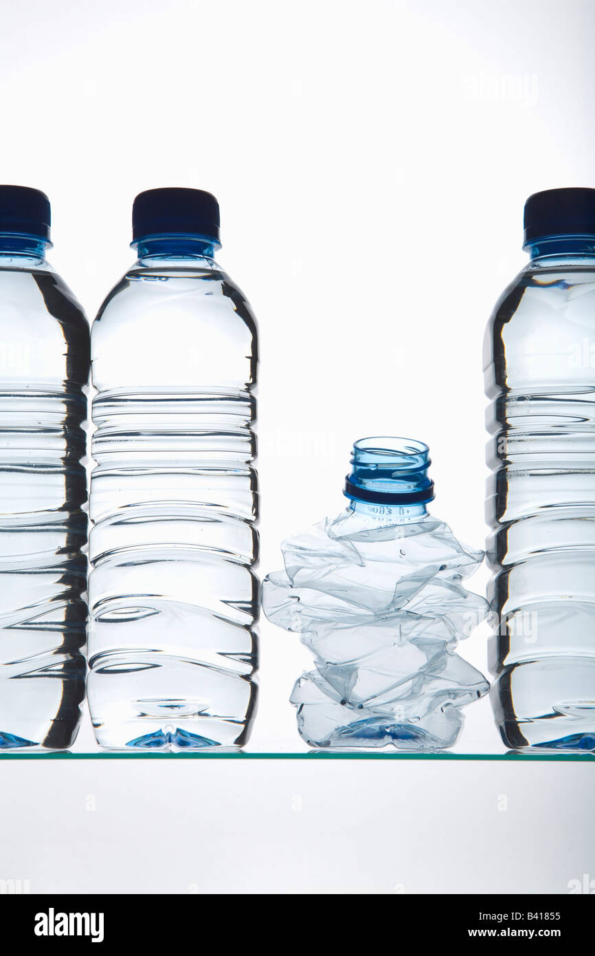 Swatted plastic bottle between filled plastic bottles Stock Photo - Alamy