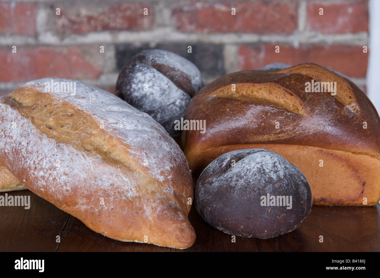 Pumpernickel, sourdough and other hard breads displayed in front of a ...