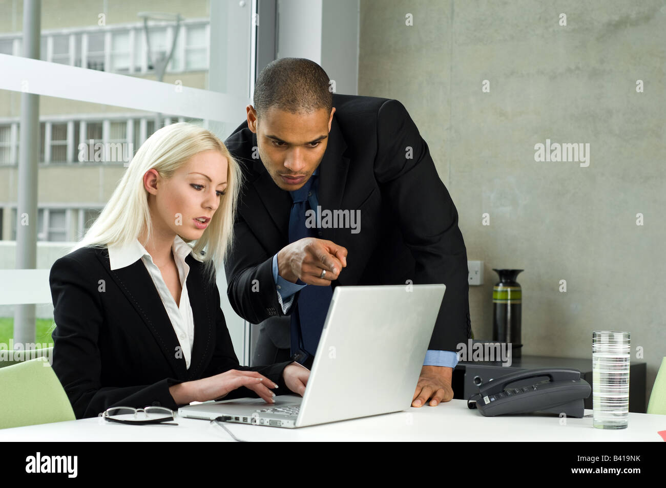 Two business people working Stock Photo - Alamy