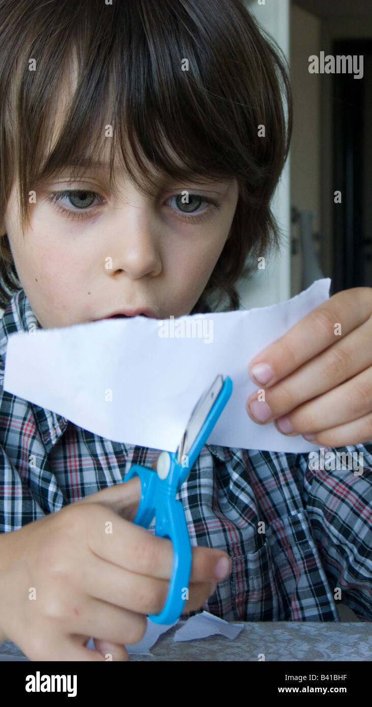 Young boy using sissors Rome Italy Model released Stock Photo - Alamy