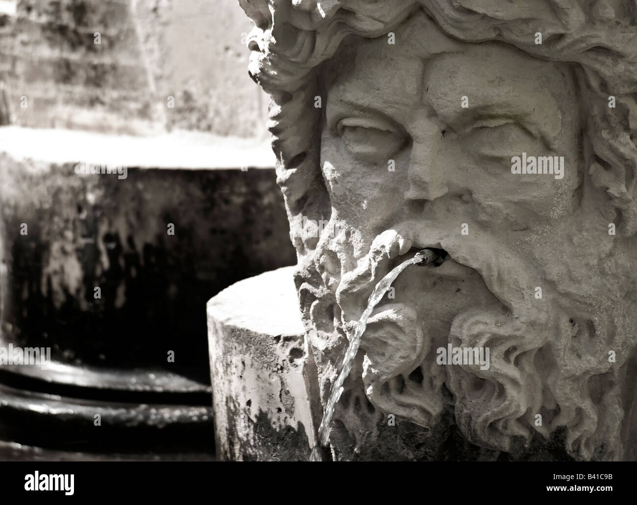 Highly eroded medieval statue in a fountain Stock Photo - Alamy