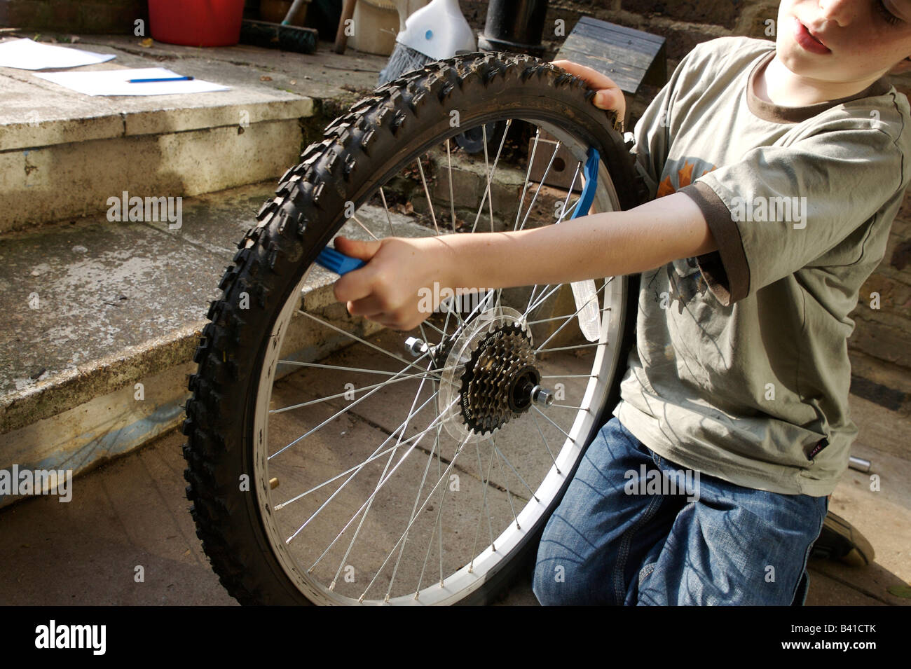 Boy fixing a puncture on his bicycle, removing the tyre Stock Photo - Alamy