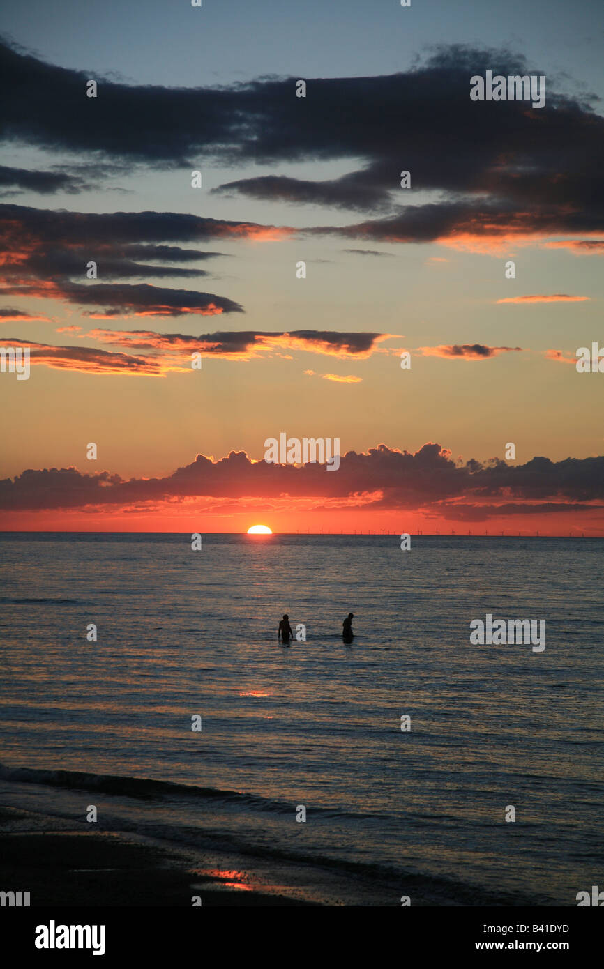 Two people swim at sunset Stock Photo - Alamy