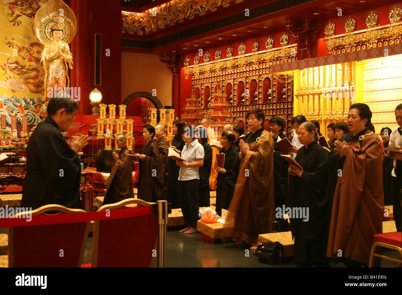 Buddhist followers during a service at The Buddha Tooth Relic Temple ...