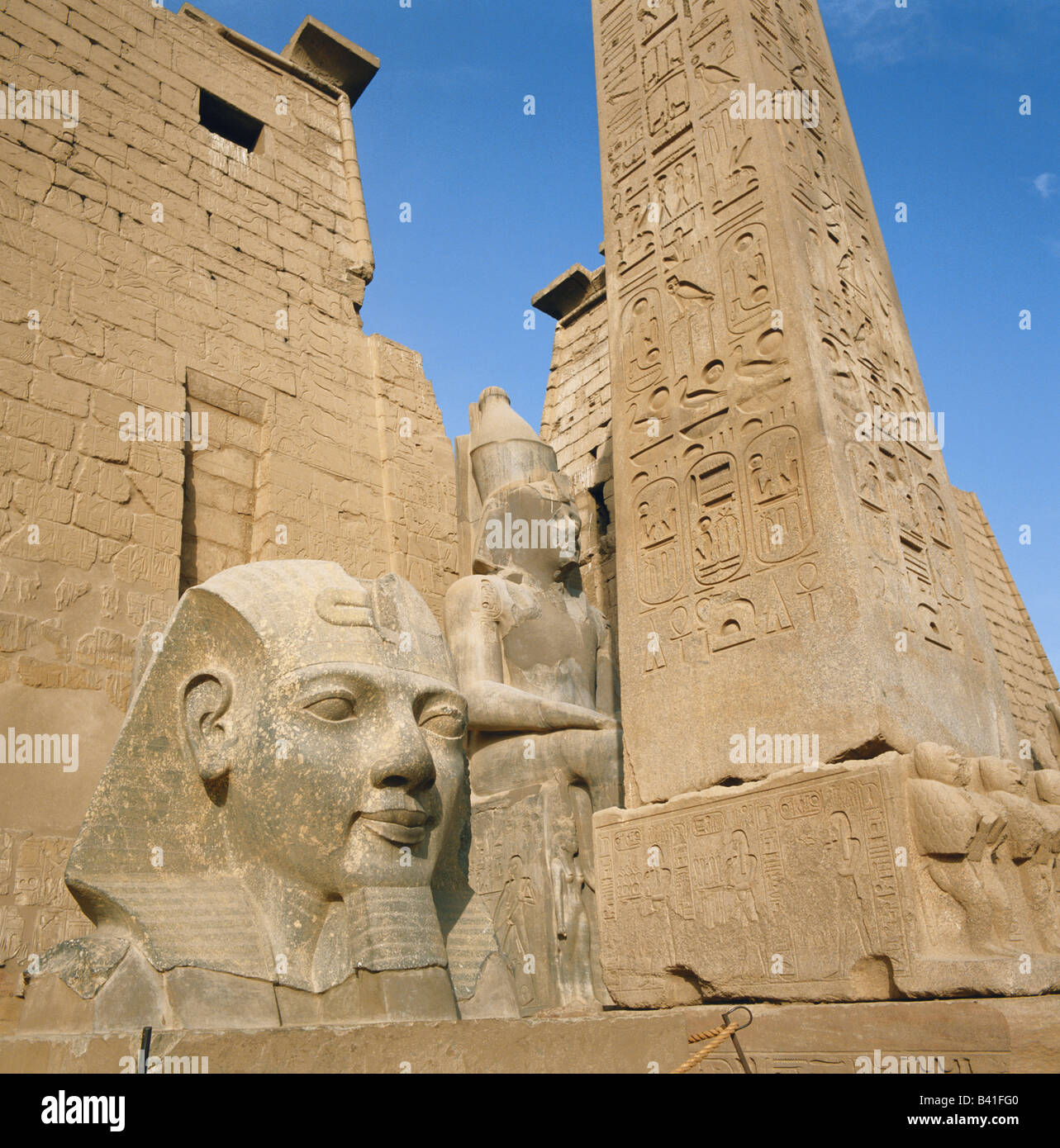 Luxor colossal head statue and obelisk at the Temple of Luxor, Egypt ...