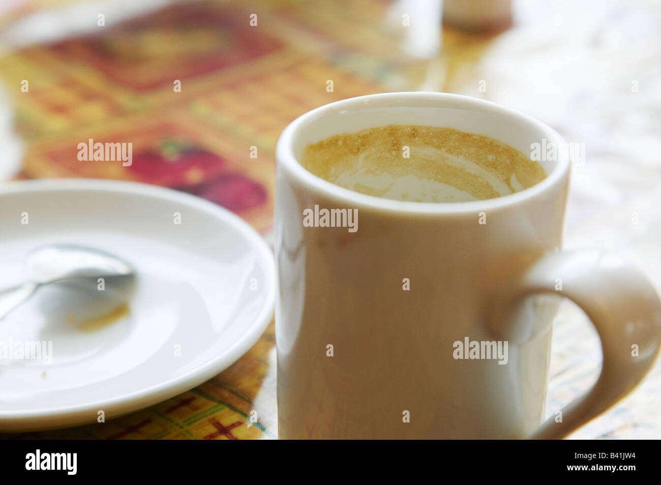 Empty plate and mug on cafe table, close-up Stock Photo - Alamy