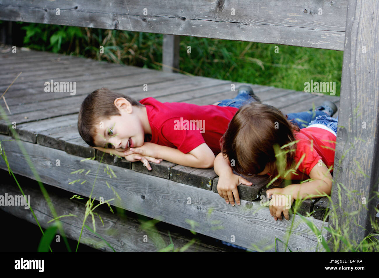 Four years old toddler boy and two years old toddler girl laying down ...