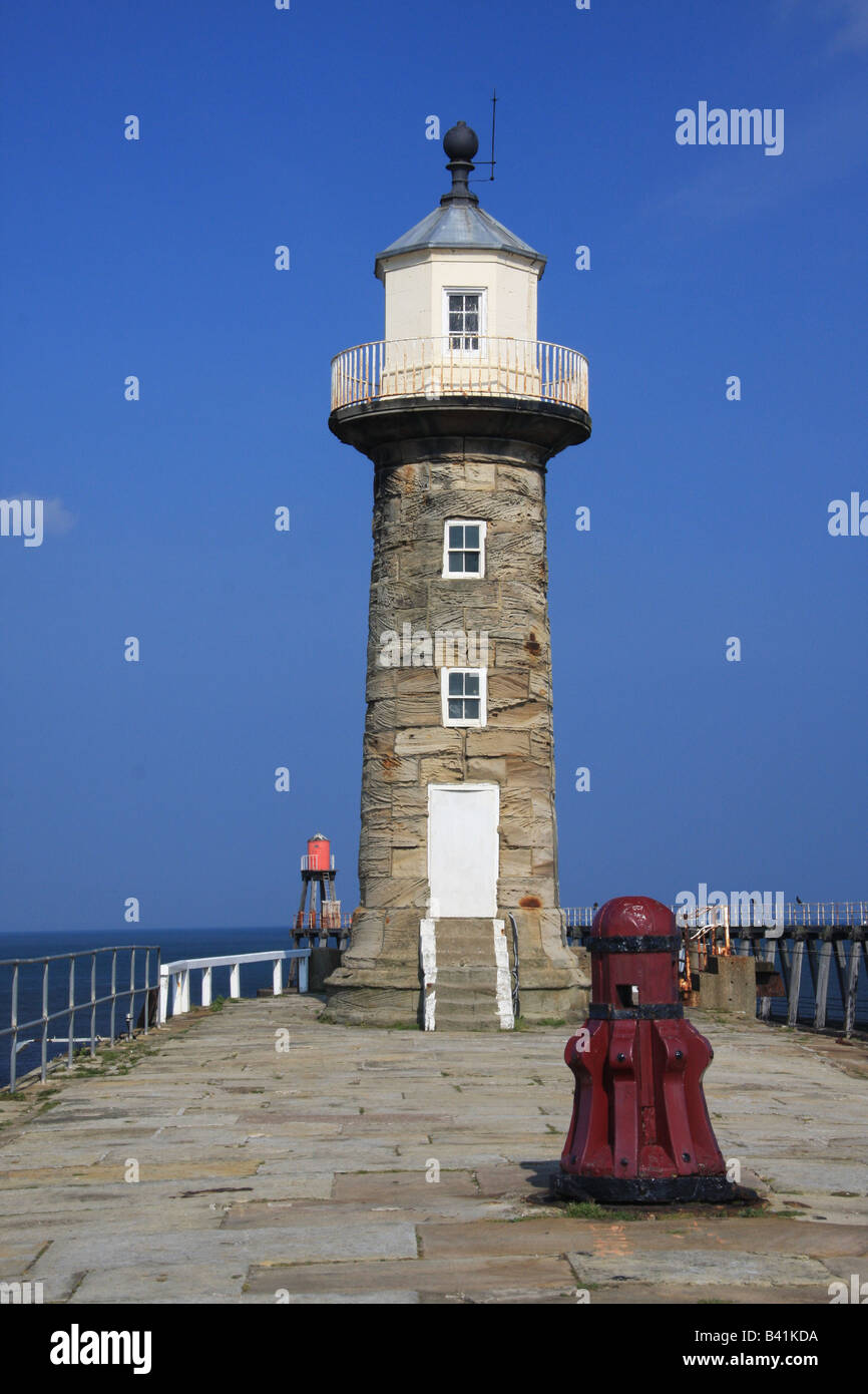 Stone lighthouse and old wooden capstan on Whitby's southern pier, set ...