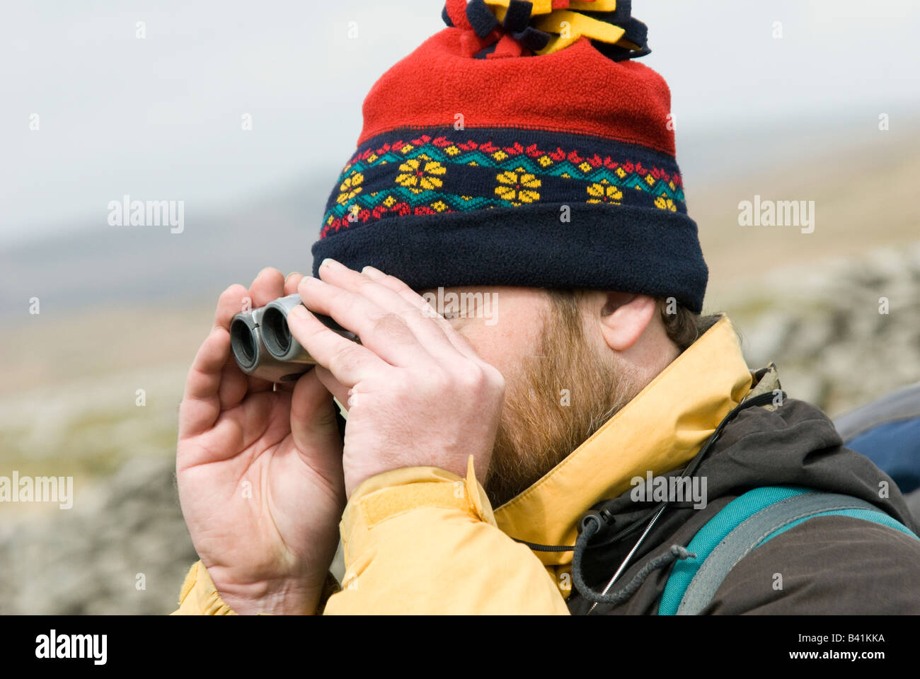 Man using a pair of binoculars in the uk countryside Stock Photo - Alamy