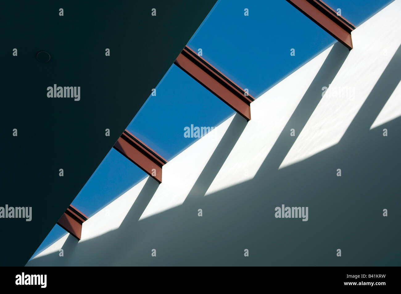 Section of a narrow skylight abstract of light and shadow under a blue ...