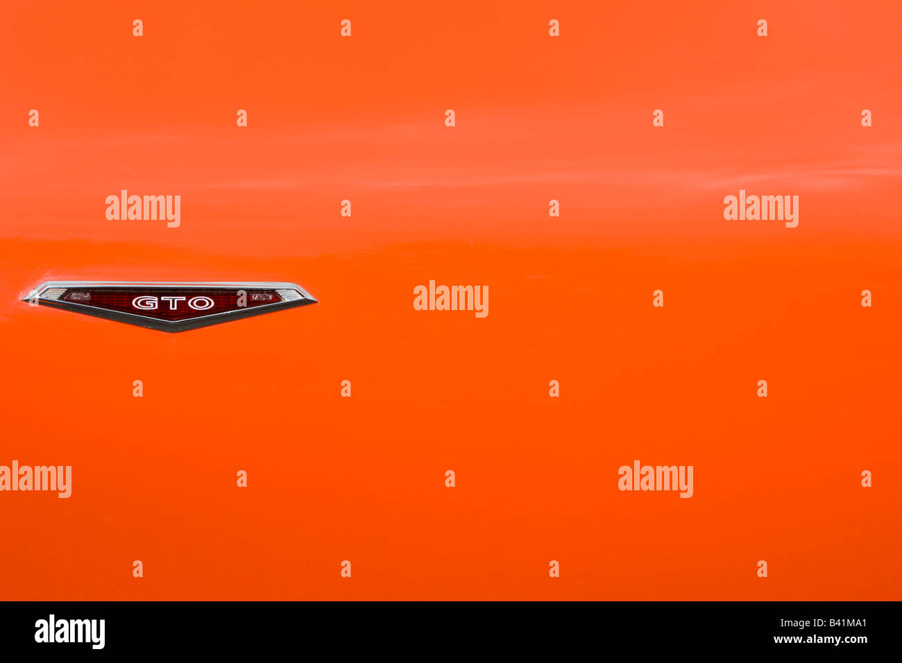 Classic Pontiac GTO badge highlighted against a solid orange background ...