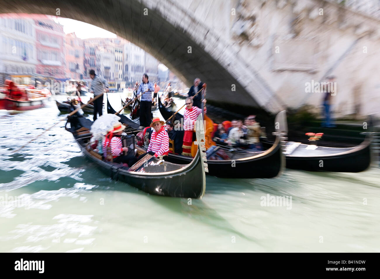 Gondoliers take their passengers in Gondalas down the Grand Canal ...