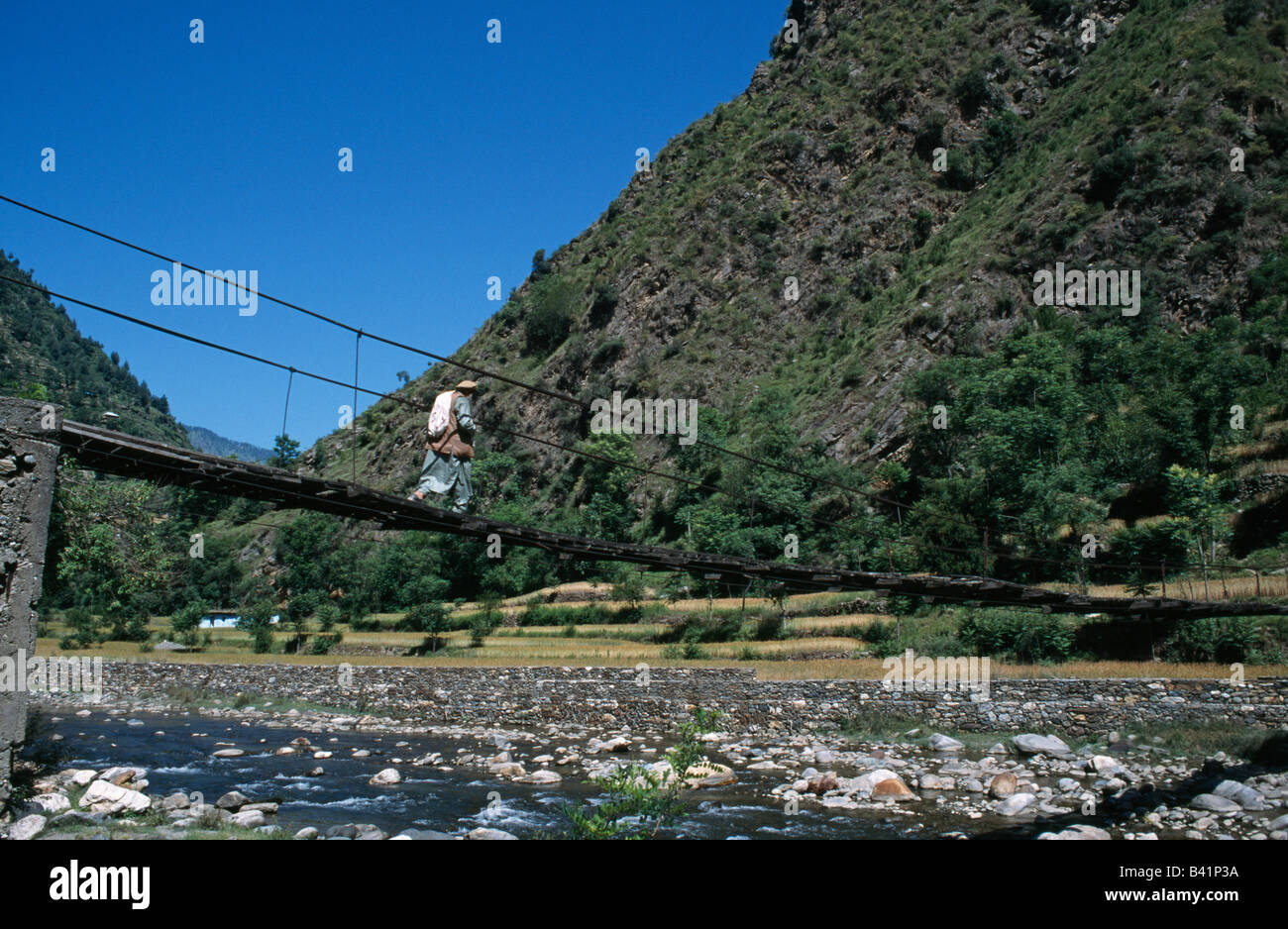 Man crossing a bridge by the Shangla Pass, near Besham, Kohistan ...