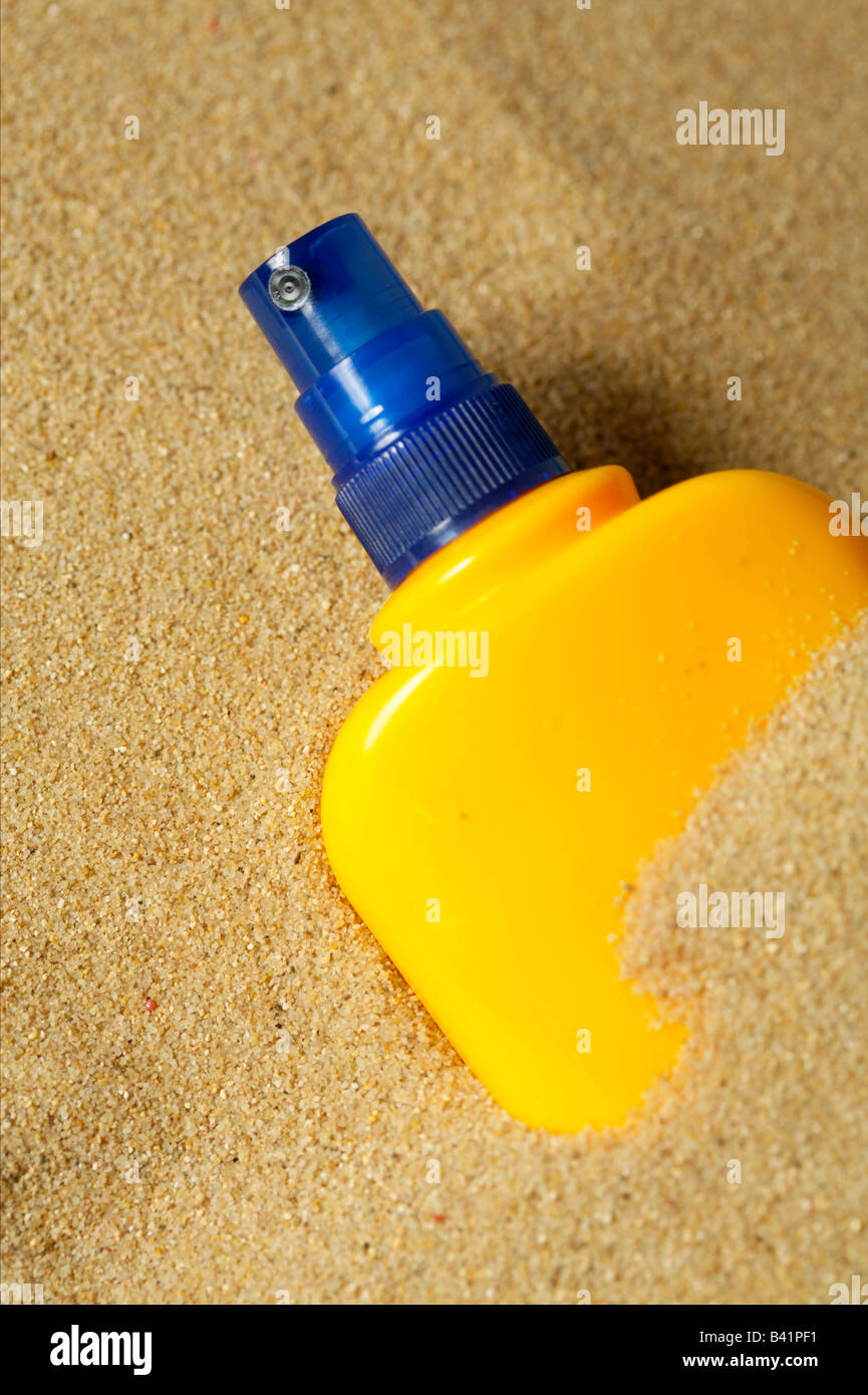 Spray bottle in the sand Stock Photo - Alamy