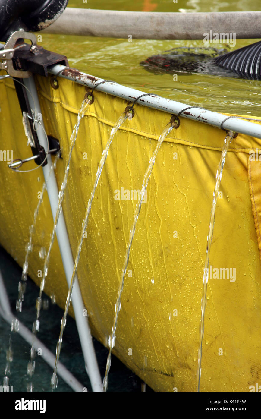 The canvas container is overflowing from water dumped from the fire ...