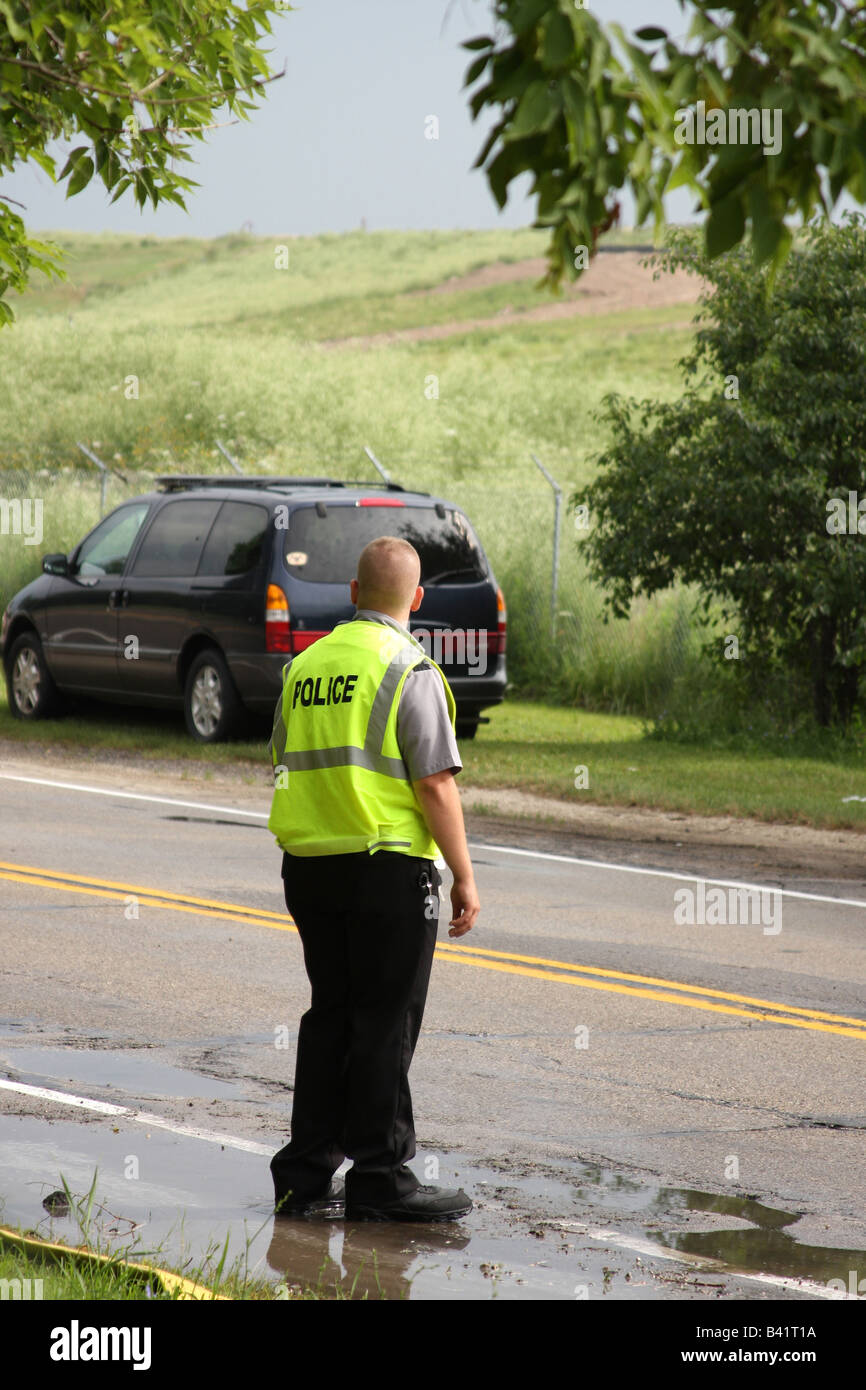 An police aid at an emergency scene directing traffic Stock Photo - Alamy