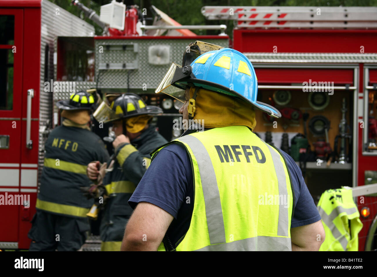 A group of firefighters at an emergency scene of a house fire Stock ...