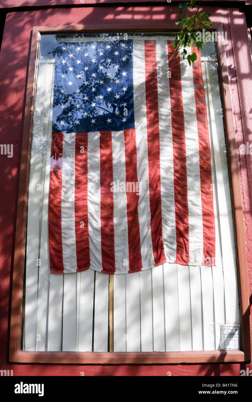An American flag in the window of a home in New York City Stock Photo ...