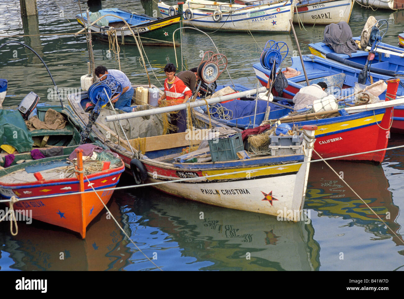 A view of fisherman and the local fishing fleet in the harbor in Lisbon ...
