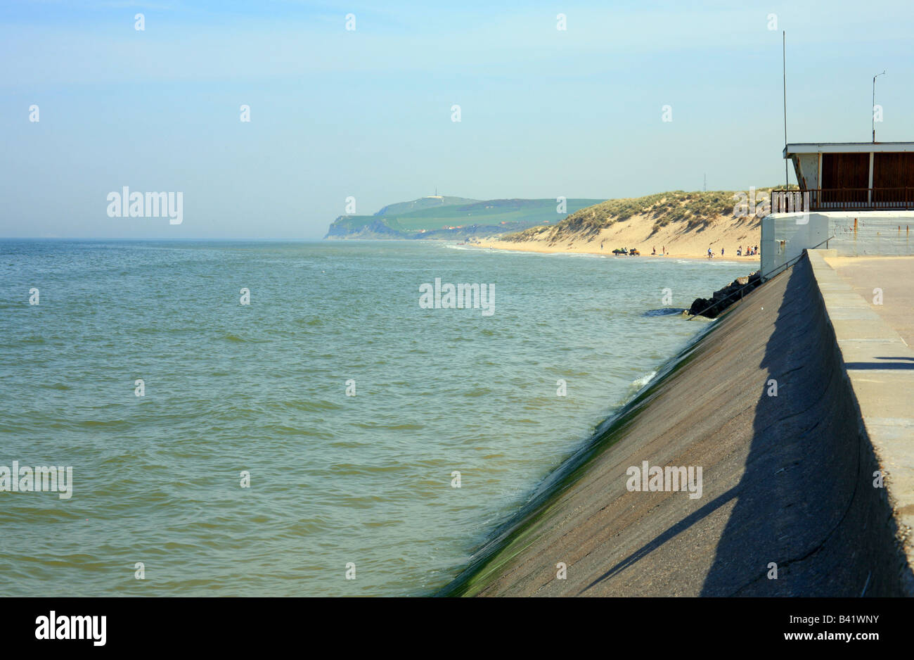 Seafront and sea wall at high tide looking towards Cap Blanc Nez ...