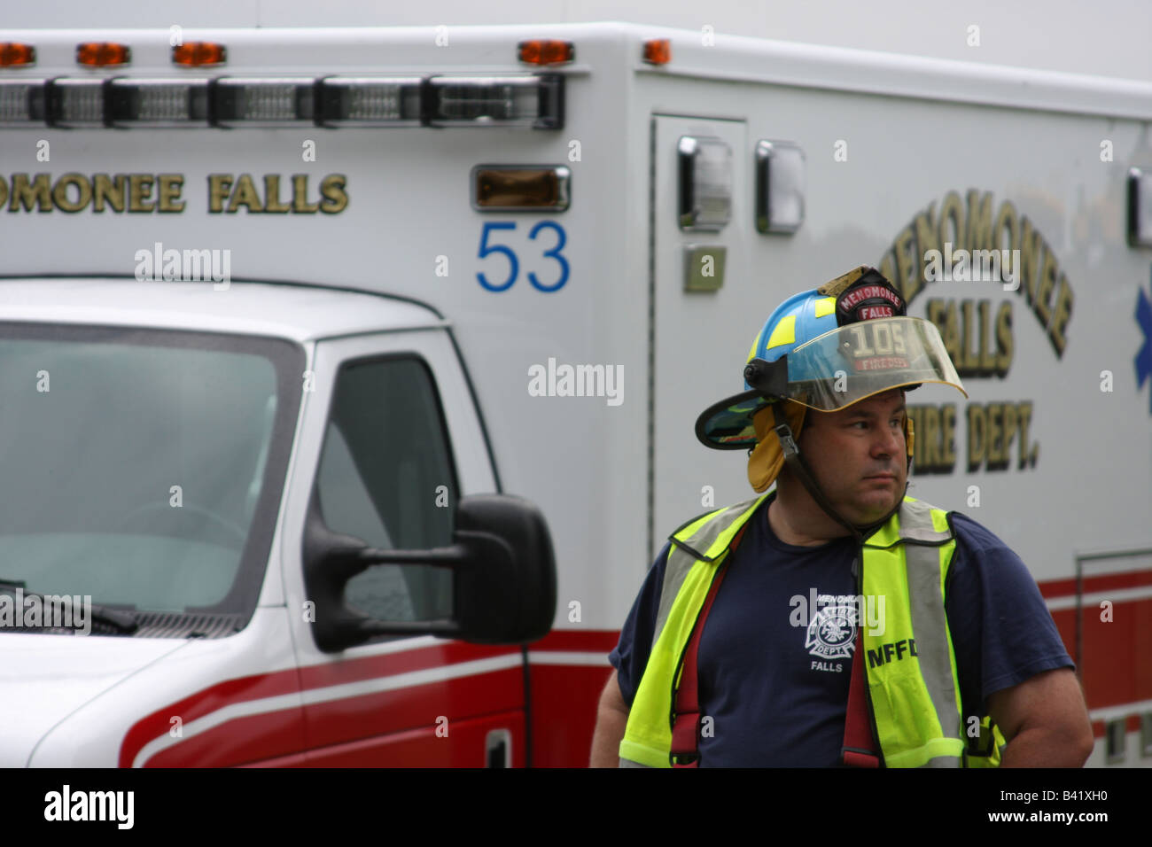 An EMT at an emergency scene with the ambulance in the background Stock ...