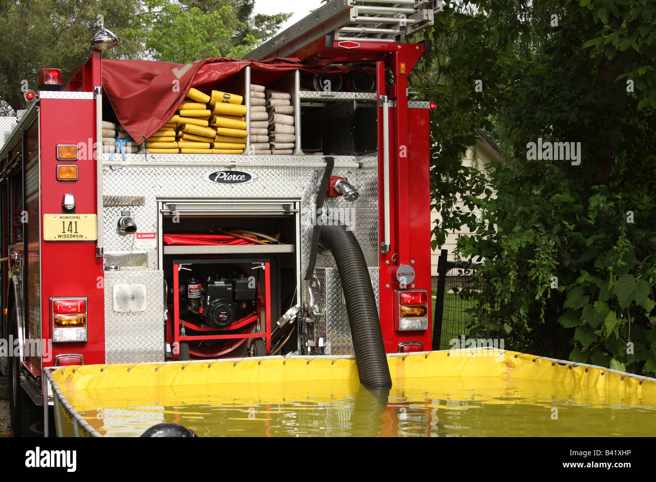 The back of a fire engine where the waterline hoses are kept ready to ...