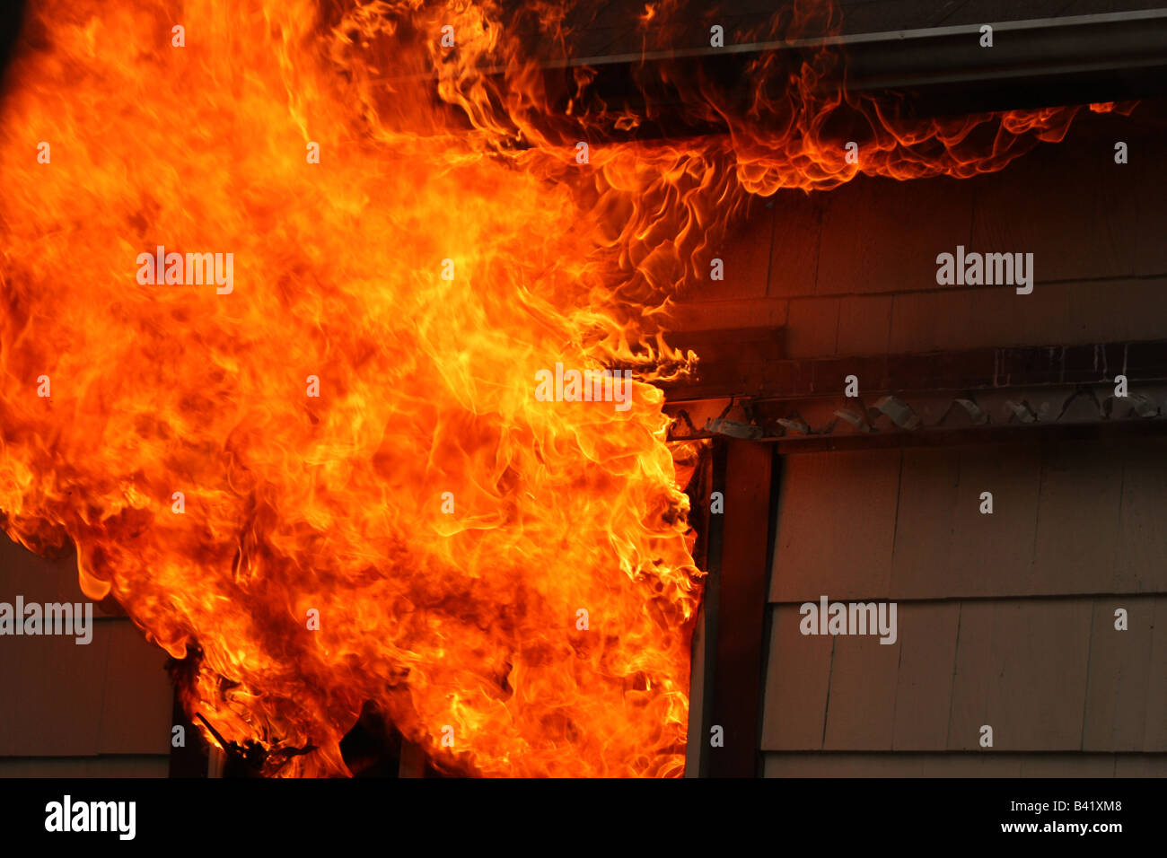 Flames exiting of a window of a residential house Stock Photo - Alamy