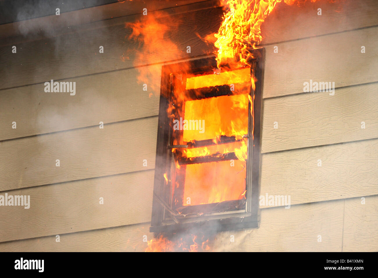 Flames coming out of a window of a residential house Stock Photo - Alamy