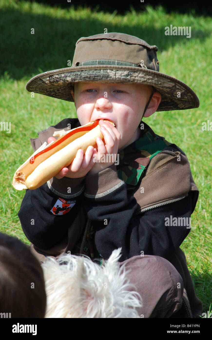 Young kid eating a foot long hot dog Stock Photo - Alamy