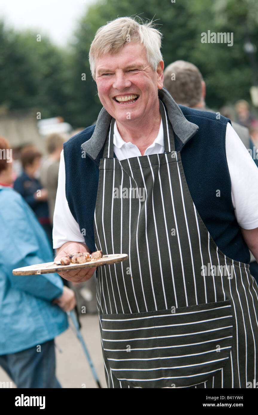 Man offering plate of food samples Food festival Ludlow Shropshire ...