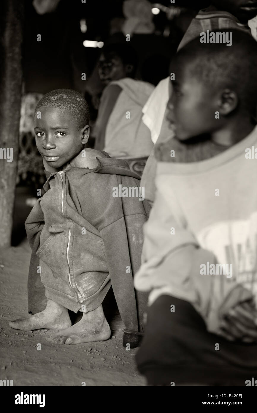 A young Rwandan boy sits on a pew during a church service Stock Photo ...