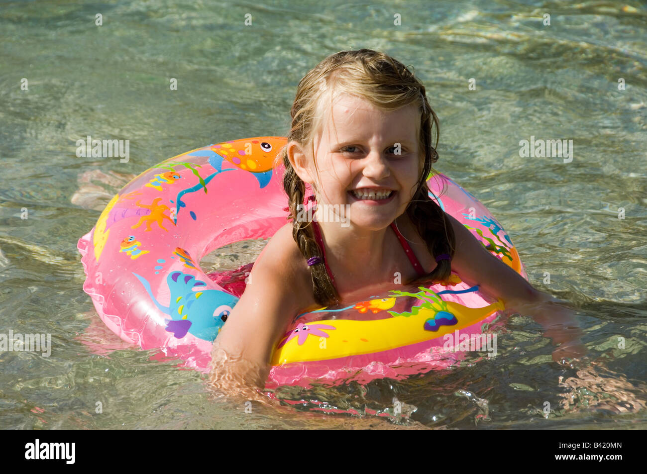 Young girl playing with inflatable ring Stock Photo - Alamy