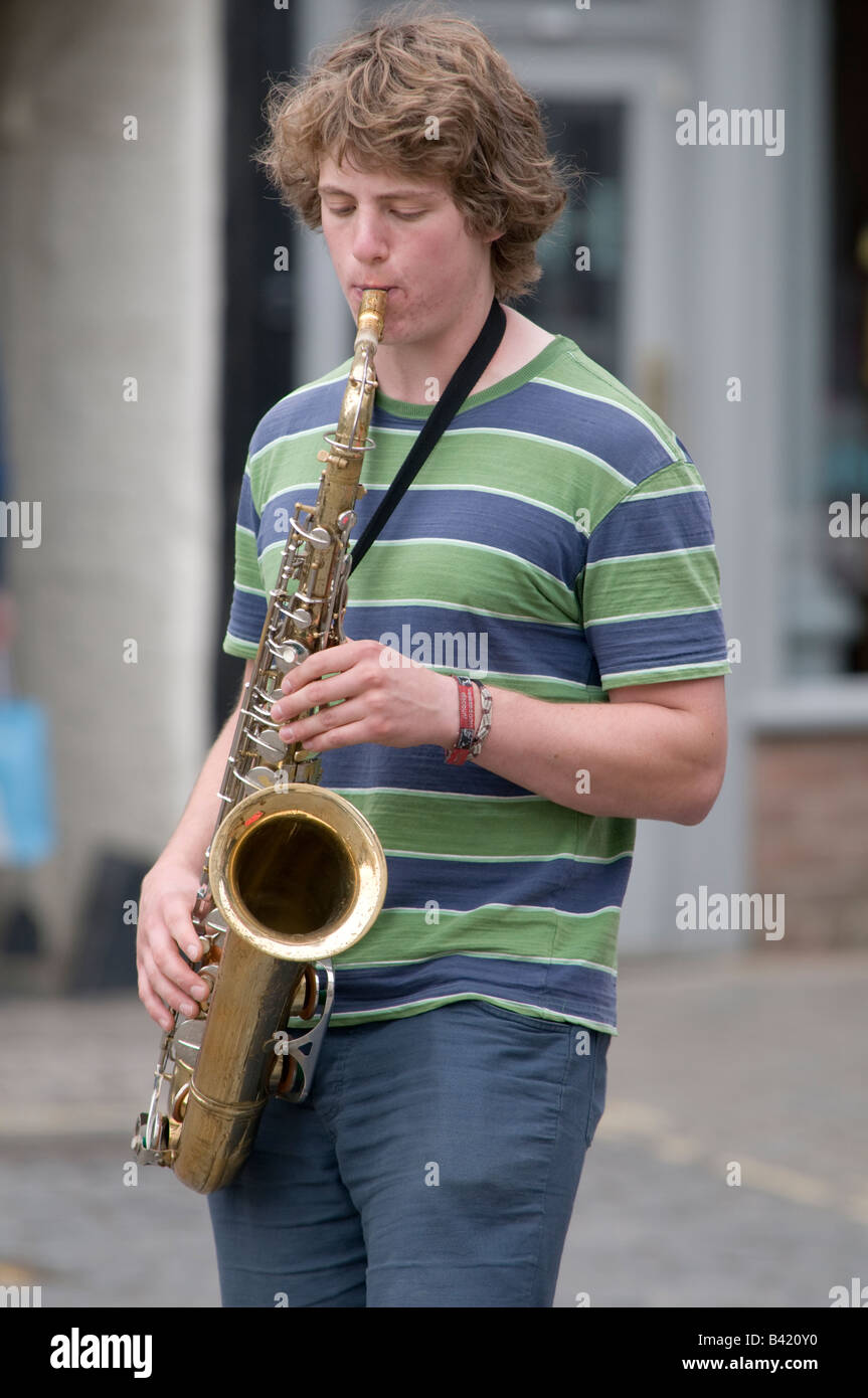 Young man boy teenager busking in the street playing saxophone Ludlow ...