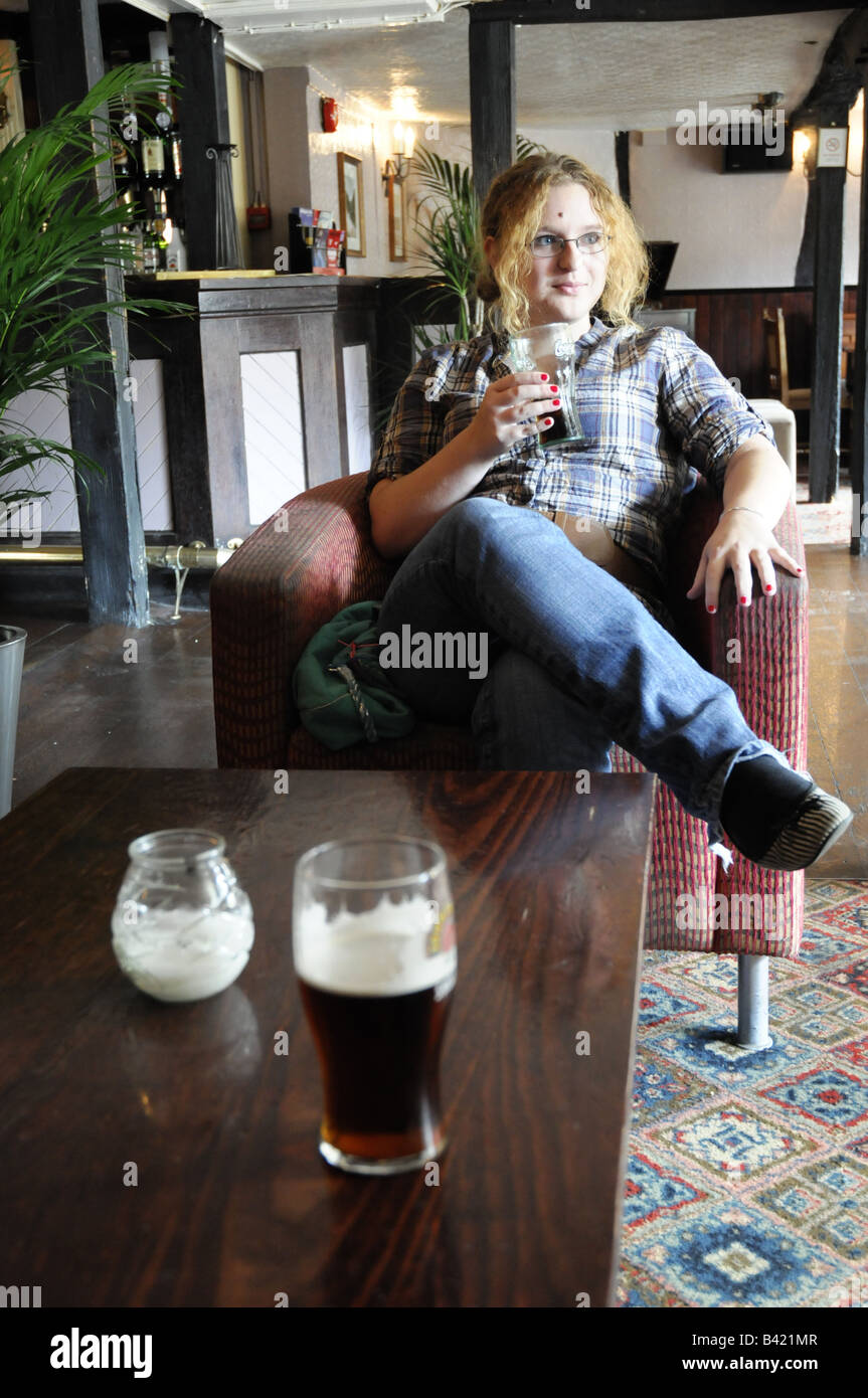 Young girl (university student) in pub Stock Photo - Alamy