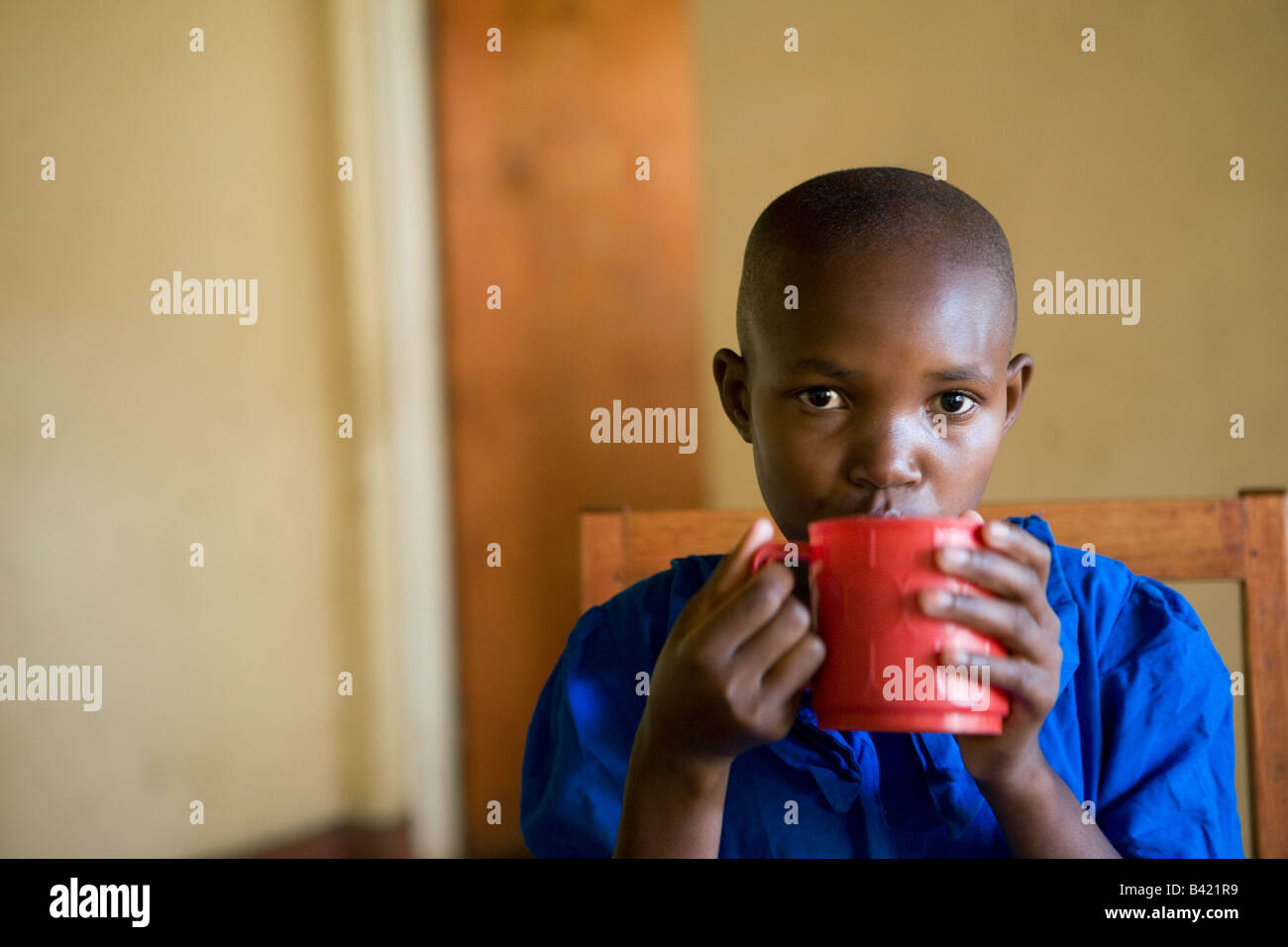 A young female student drinks her porridge before going to school Stock ...