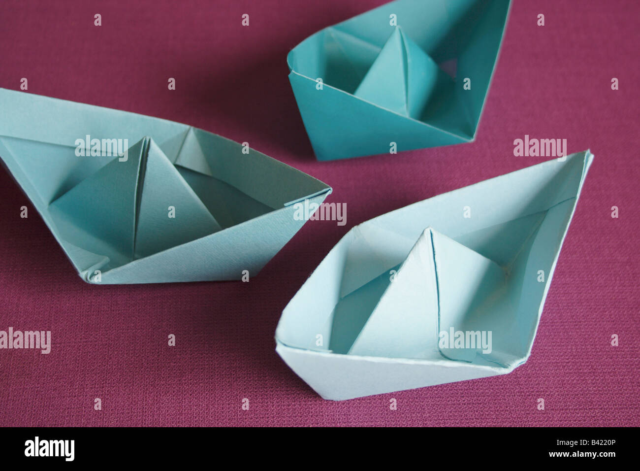 three blue paper boats Stock Photo - Alamy