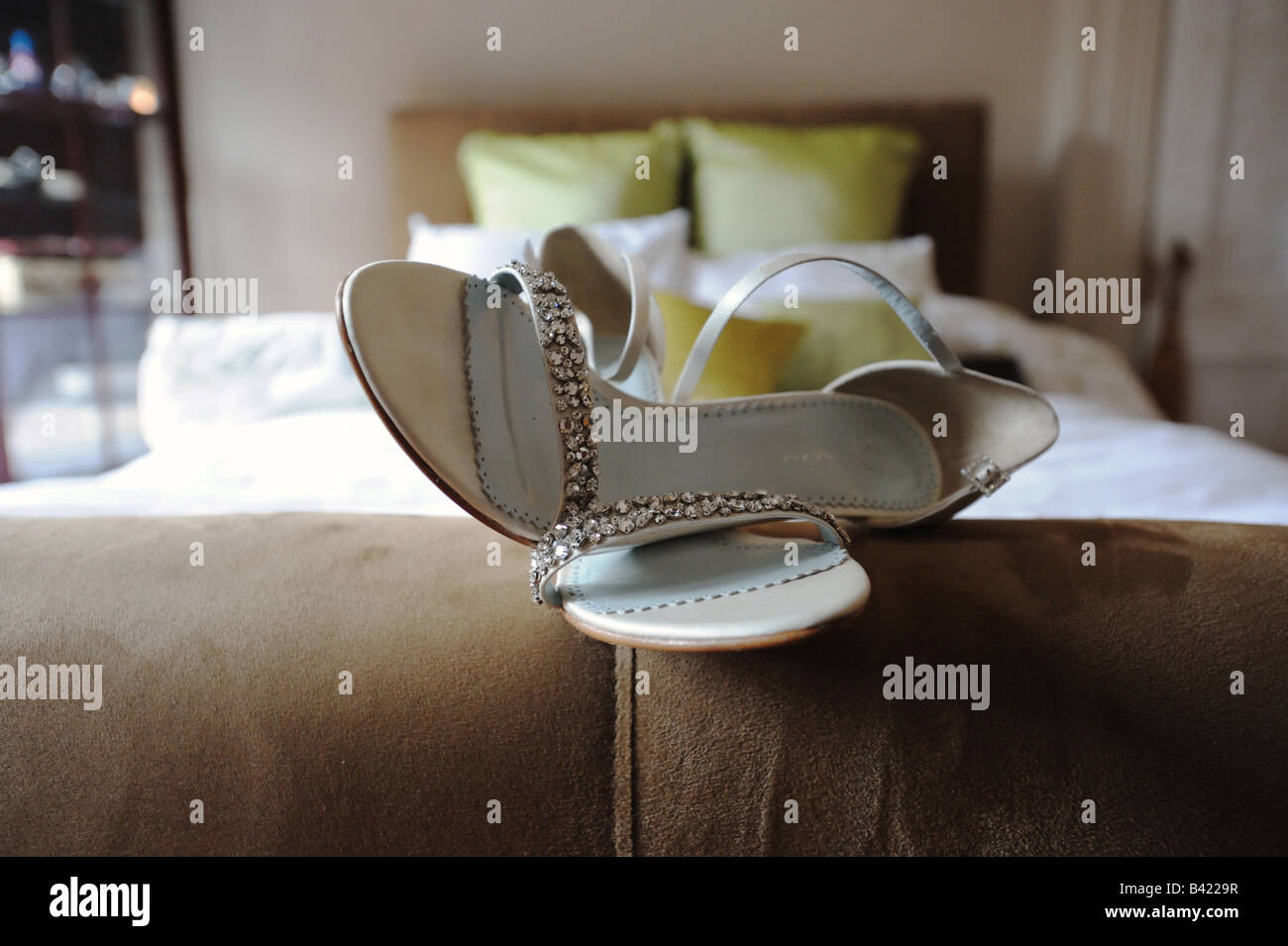 shoes on the foot of the bed Stock Photo - Alamy