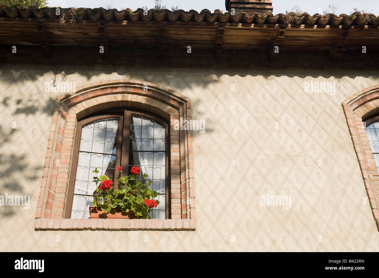 Medieval hause window with geraniums in Grazzano Visconti, Italy Stock ...
