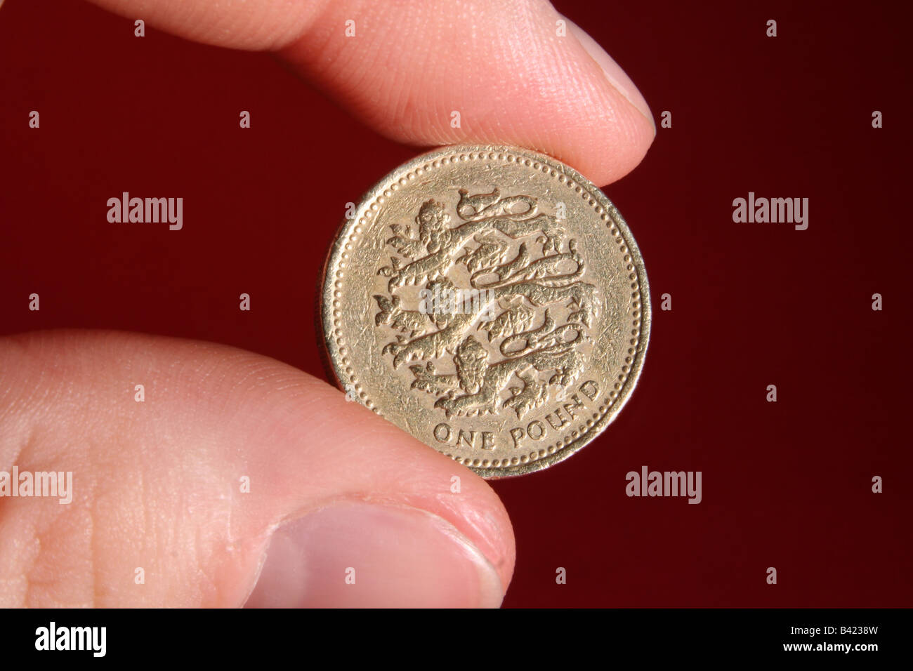 Hand holding a pound coin Stock Photo - Alamy