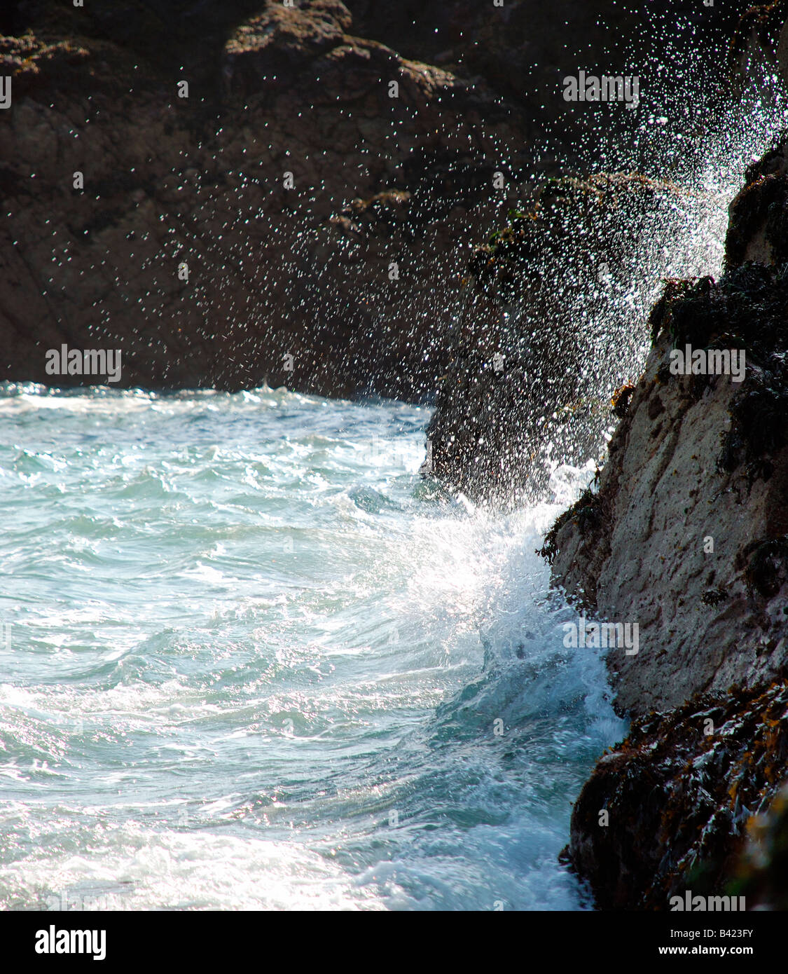 wave splashing on rocks Stock Photo - Alamy