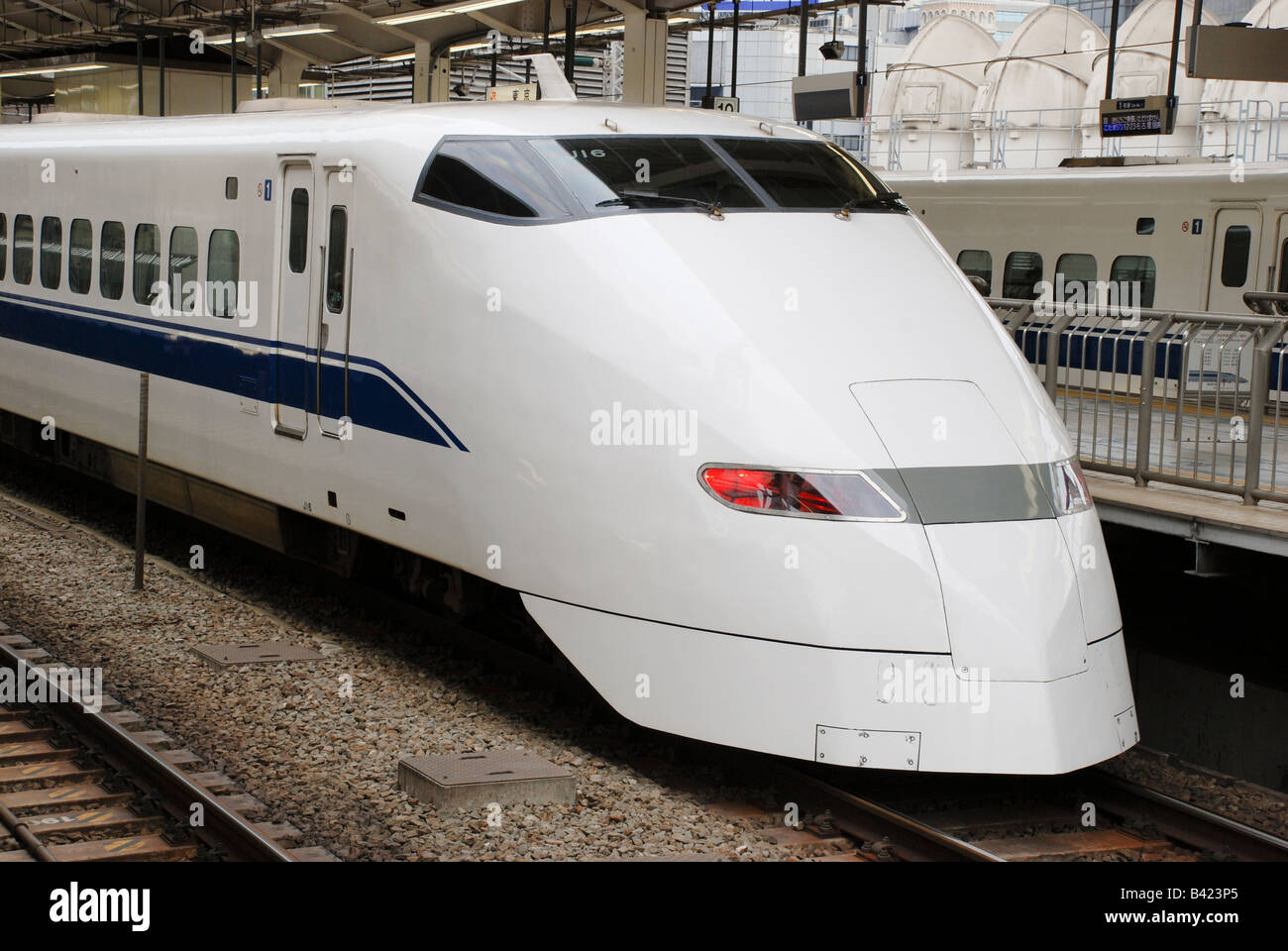 Modernistic Shinkansen bullet train pulls into the platform on the ...