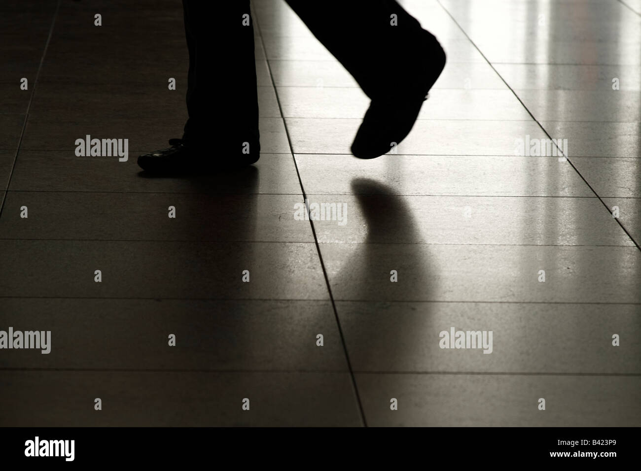 Close up footsteps of a walking man. Silhouette & shadow Stock Photo ...