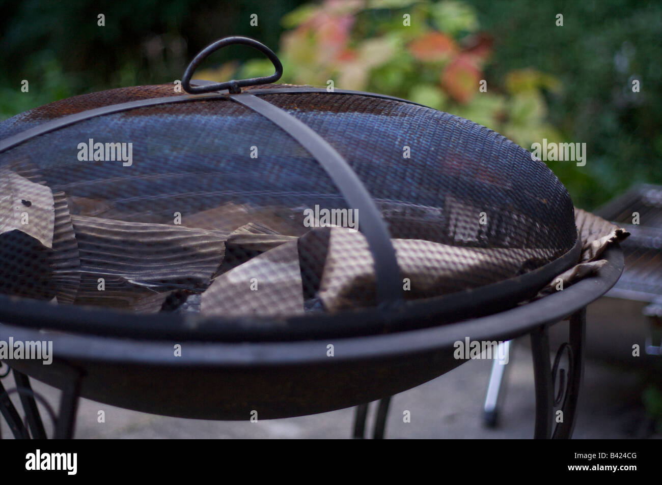 garden fire burner log wood metal patio Stock Photo - Alamy