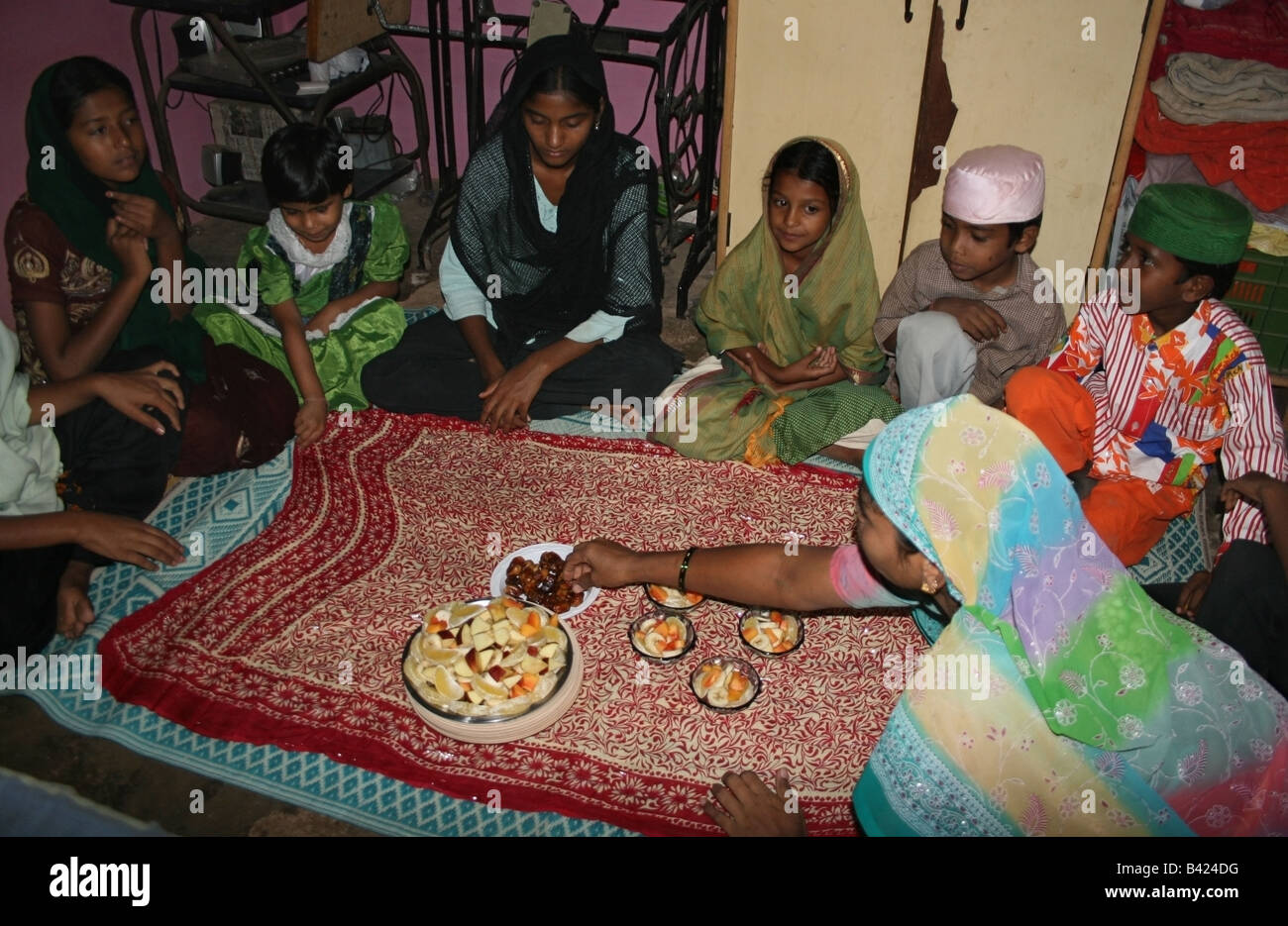 Extended Muslim family breaking the fast with dates and fruit before ...