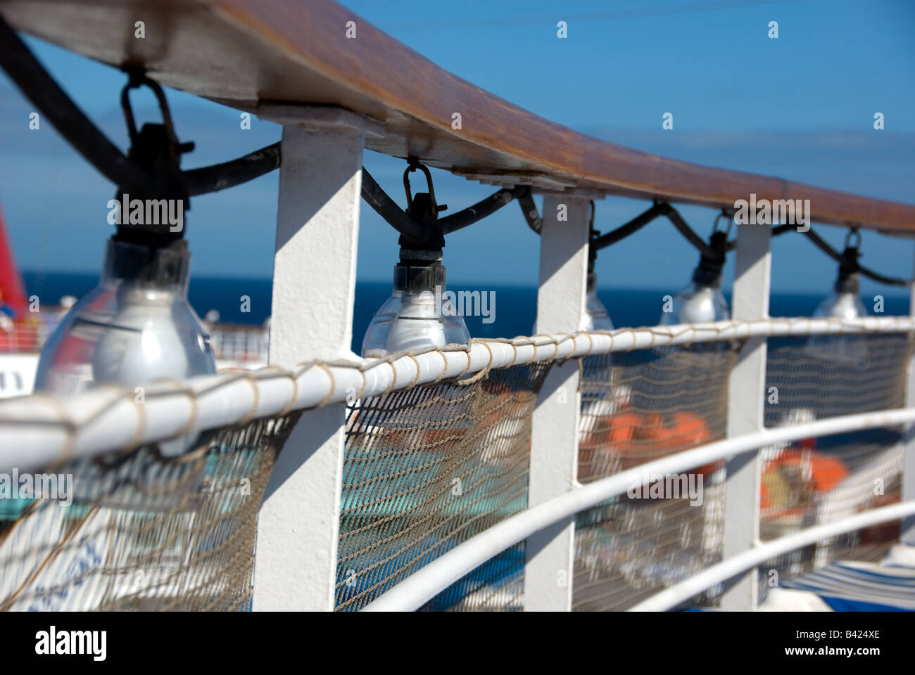 Railing with lights on cruise ship Ocean in the background Stock Photo ...