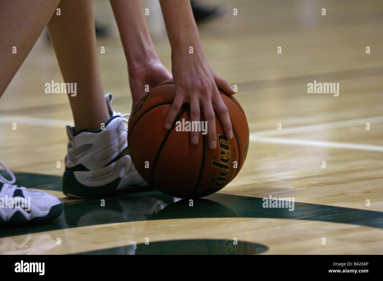 A basketball being picked up by an unseen player so they can throw it ...
