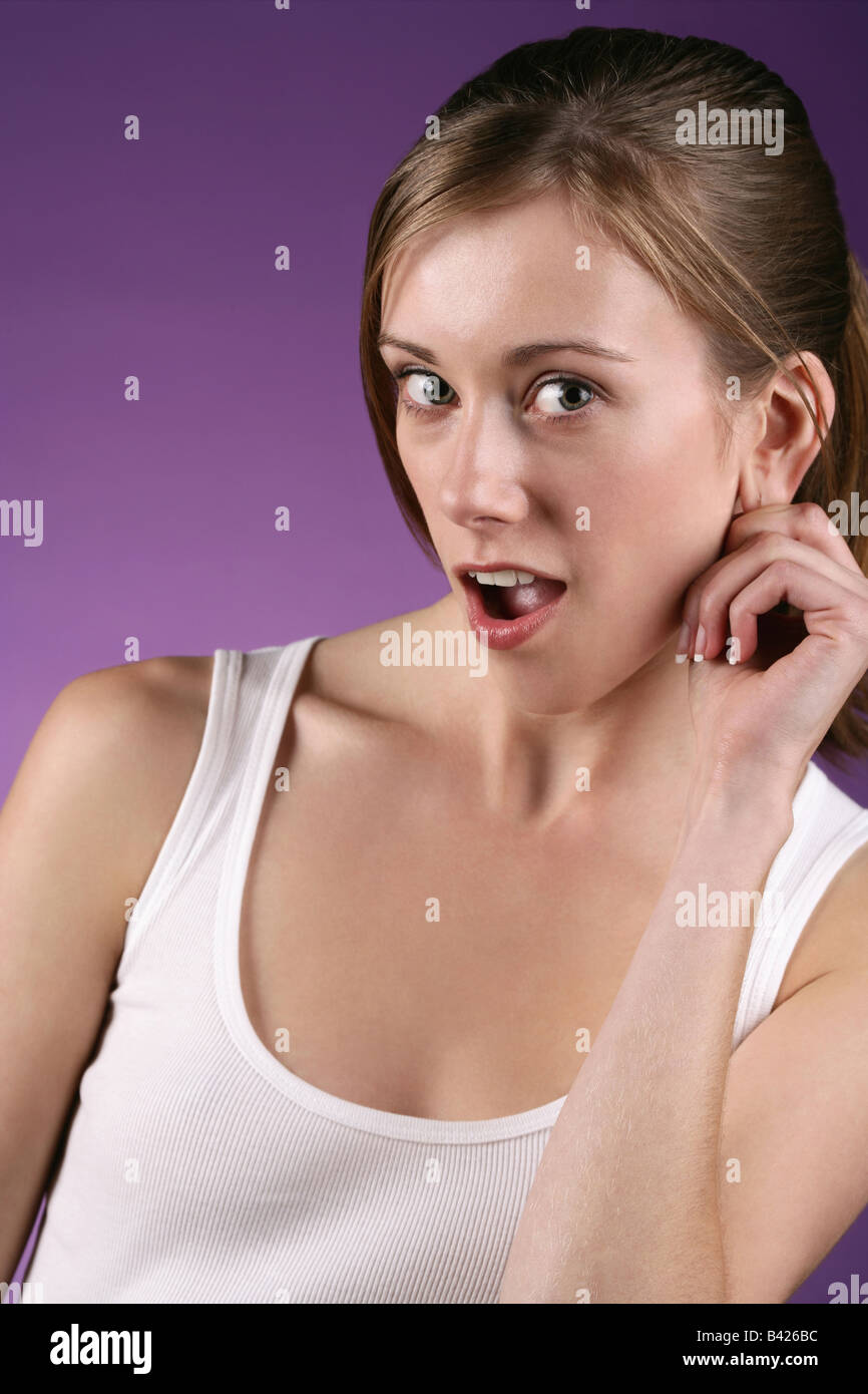 Female model holding her ear Stock Photo - Alamy